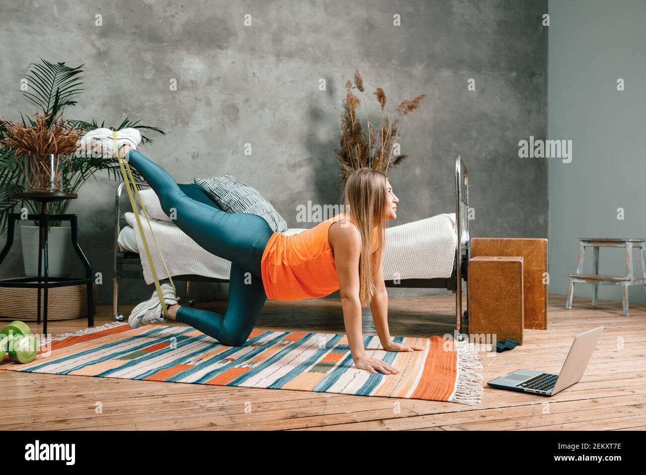 A young woman goes in for sports at home, online workout from the ...