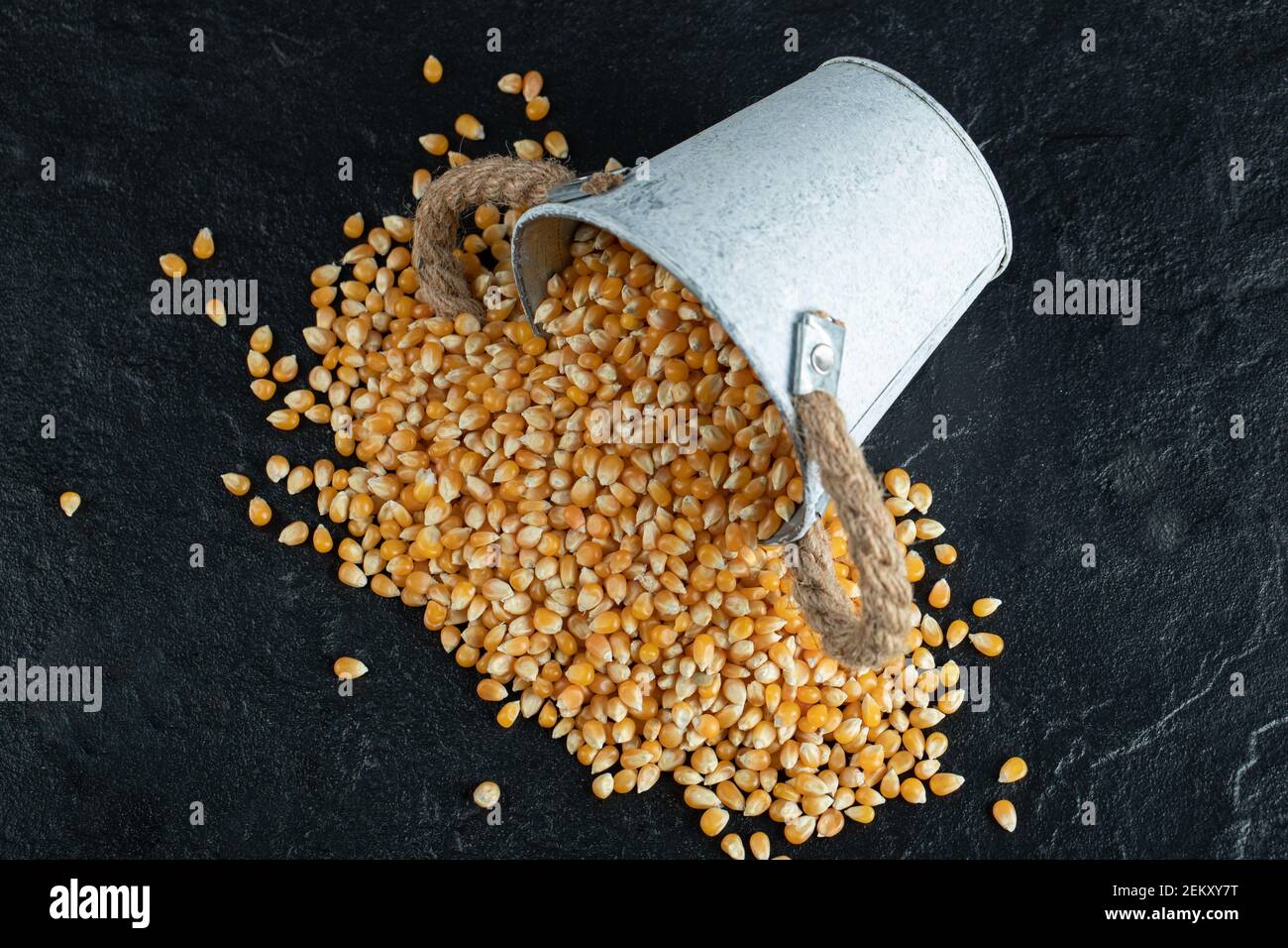 An iron bucket with uncooked corn grains Stock Photo - Alamy