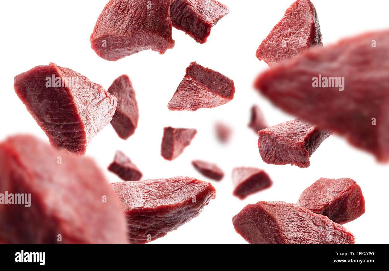 Pieces of fresh meat levitate on a white background Stock Photo - Alamy