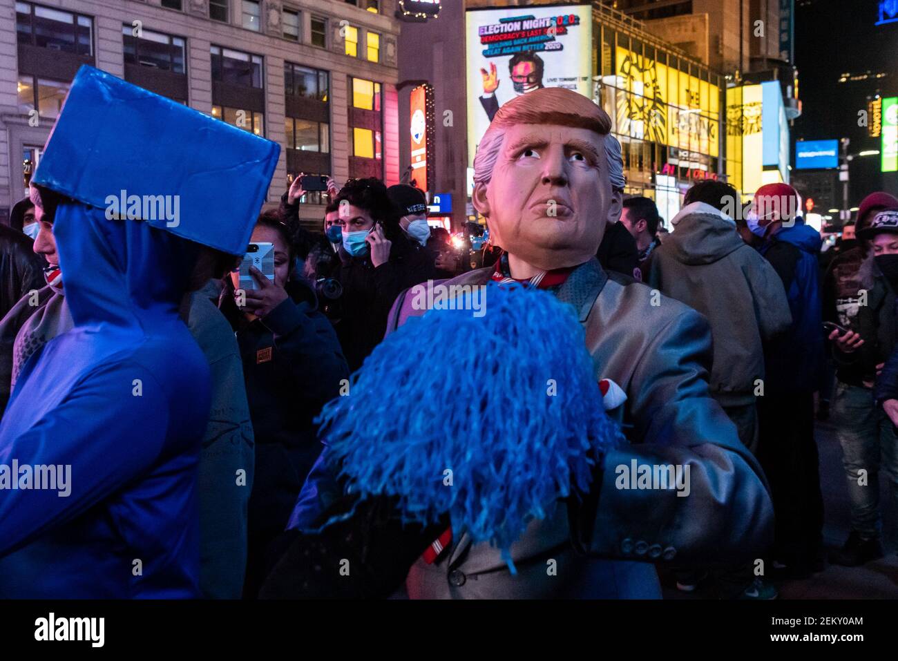 A New Yorker wearing a Trump mask walks through Times Square in New ...
