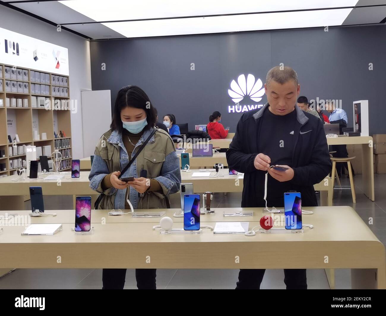 People line up at a local Huawei authorized experience store to rush to ...