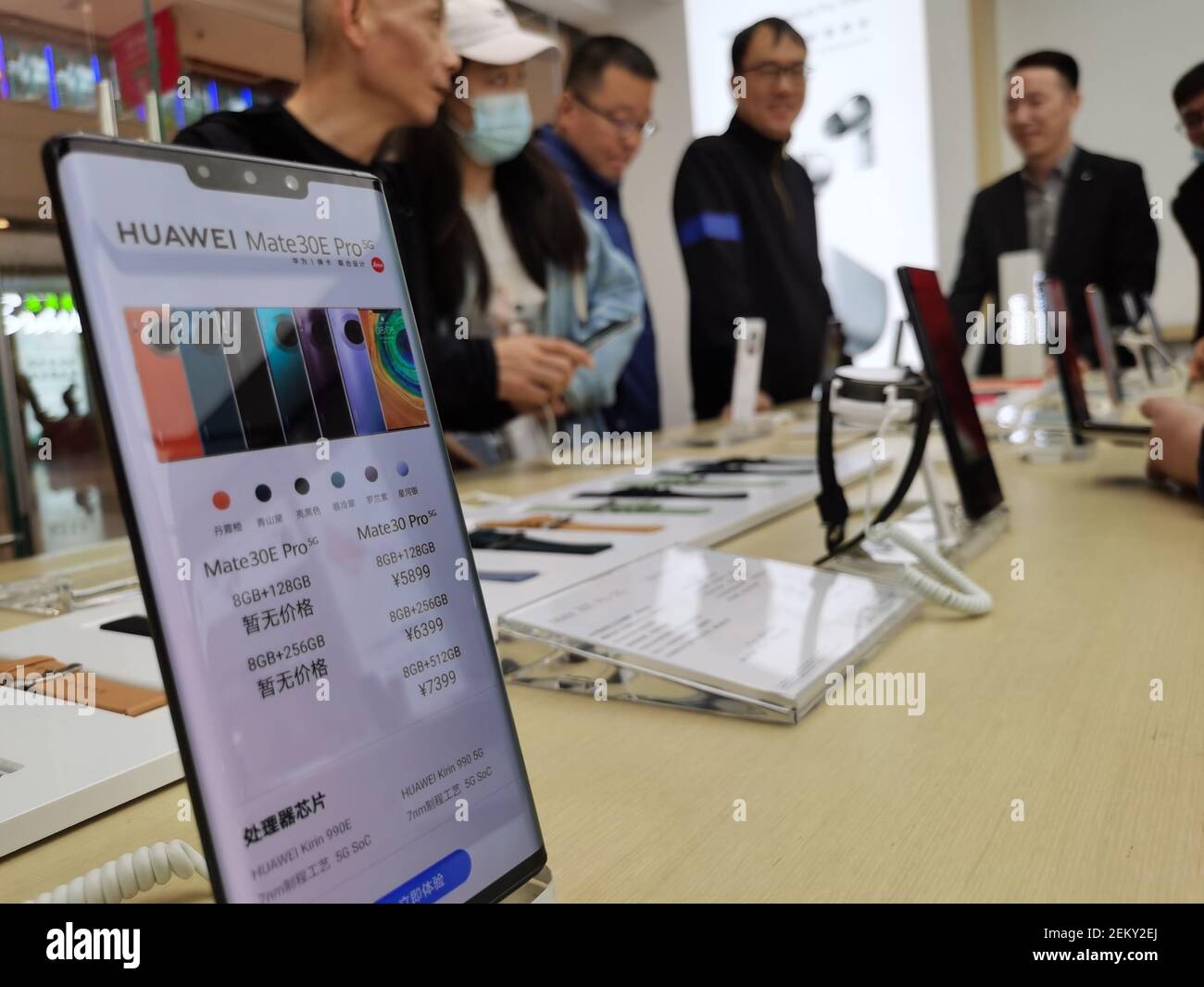 People line up at a local Huawei authorized experience store to rush to ...