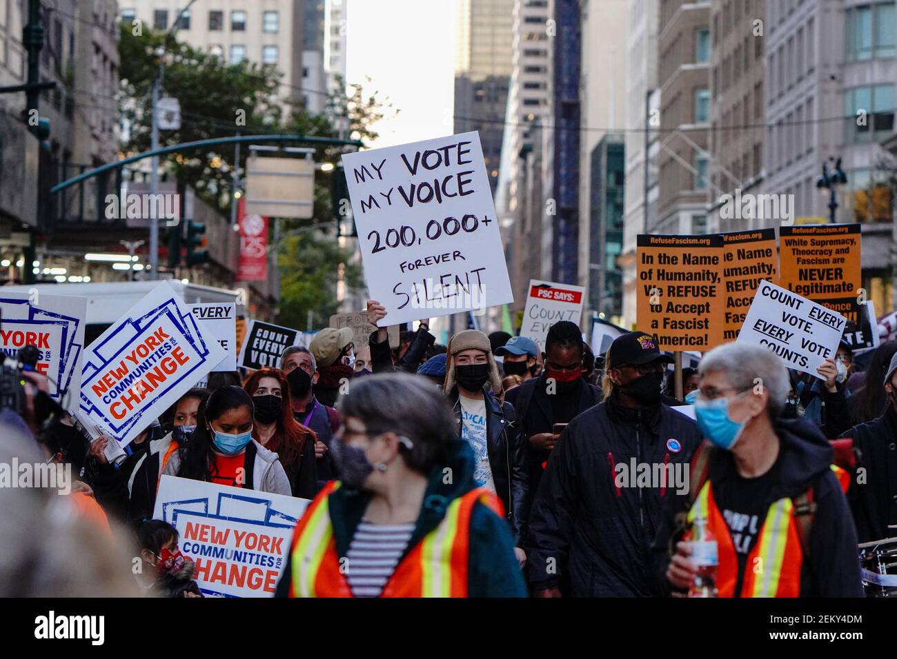 Protesters march while holding placards during the demonstration ...