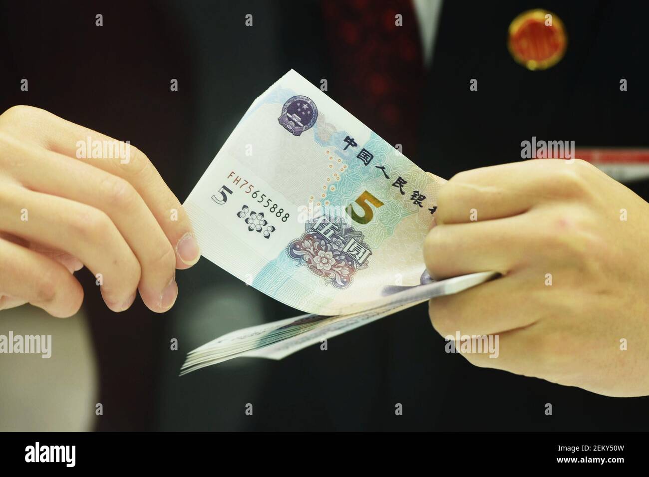 CHINA-A staff member of China Citic Bank hangzhou Branch counts the ...