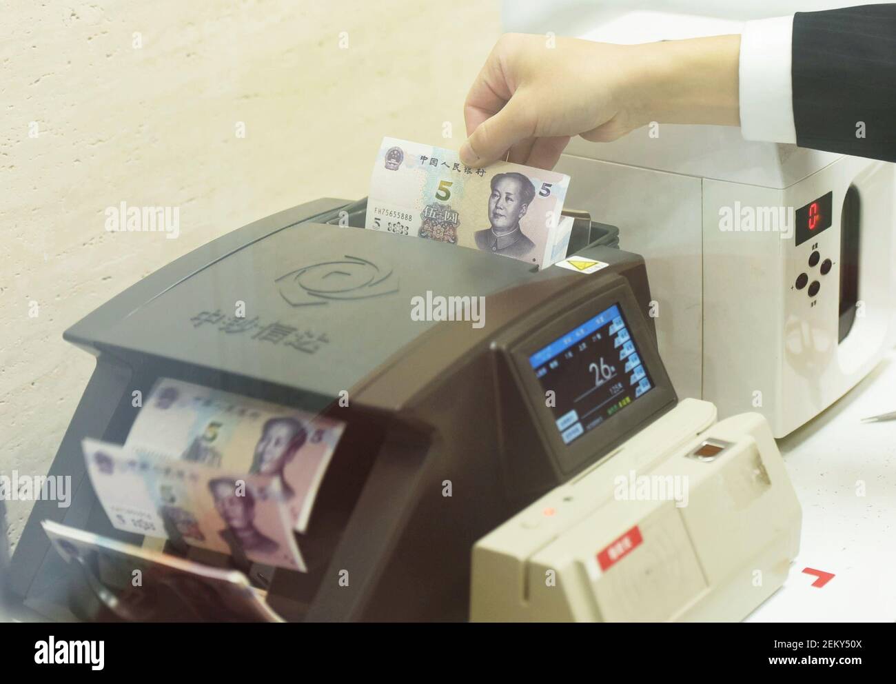 CHINA-A staff member of China Citic Bank hangzhou Branch counts the ...