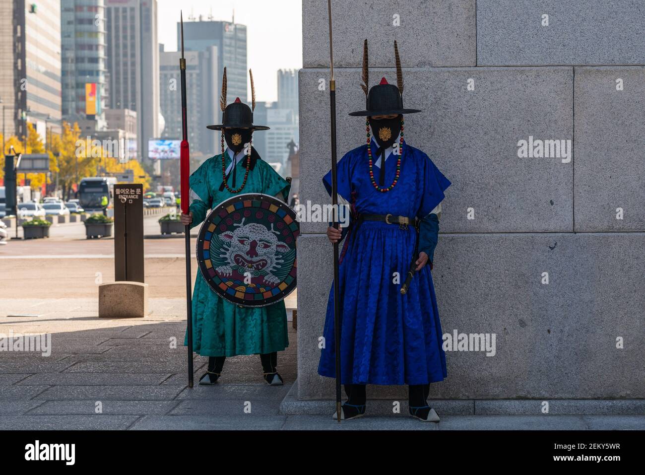 Royal Guards wearing face masks stand at the main gate of Gyeongbokgung ...