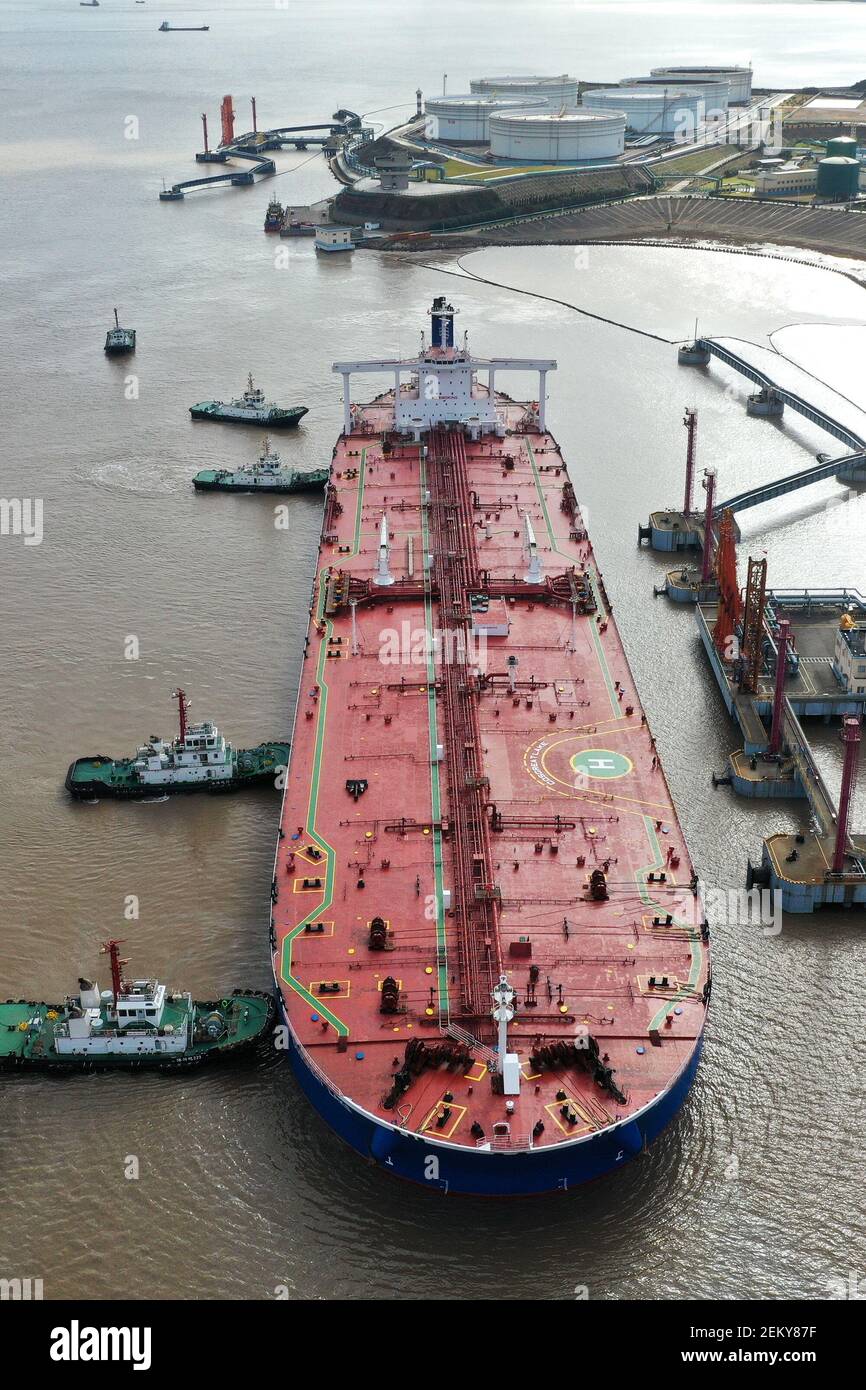 Workers of the port unload crude oil form an oil tanker harboring in ...