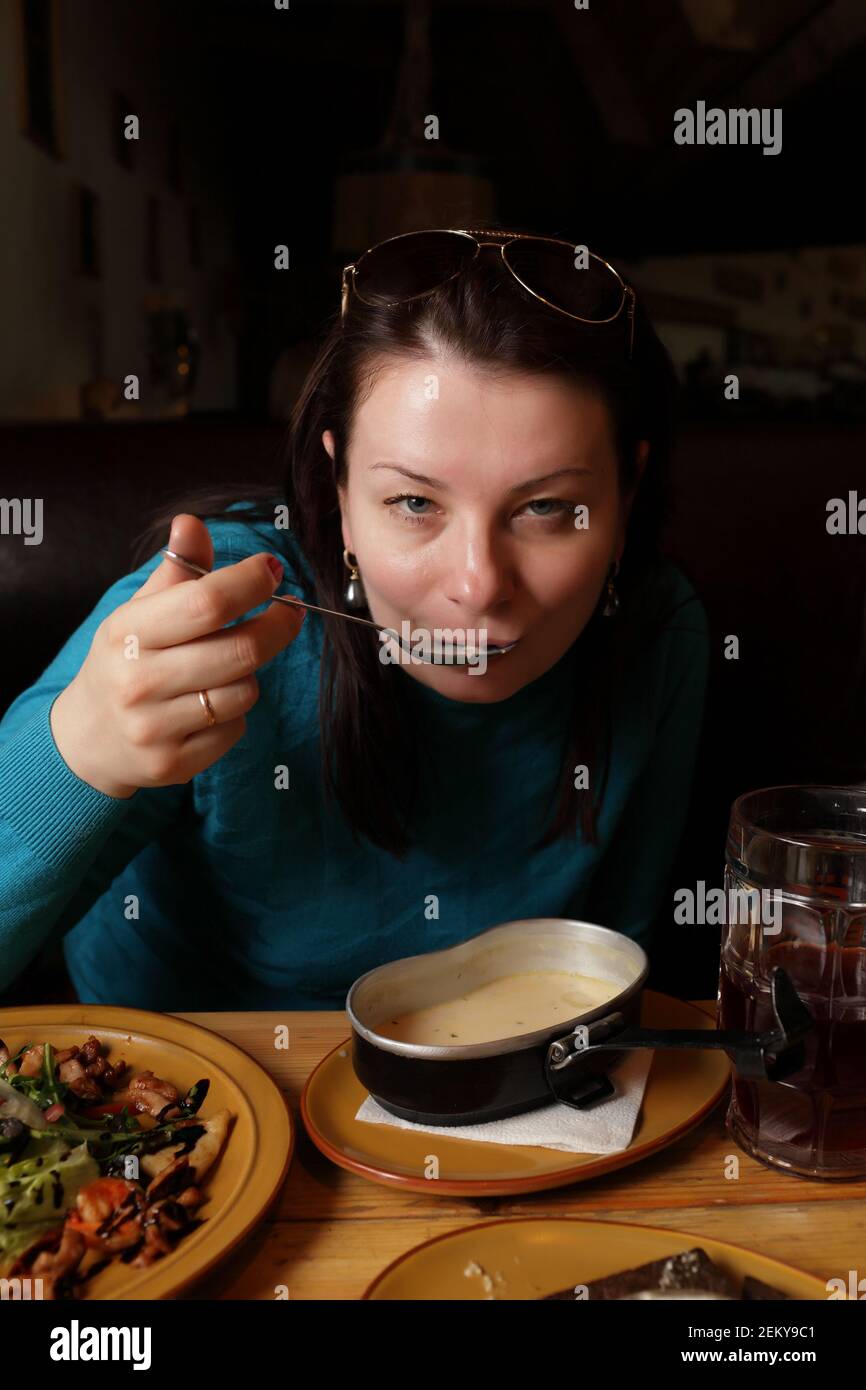 Woman eating fish soup in the restaurant Stock Photo - Alamy