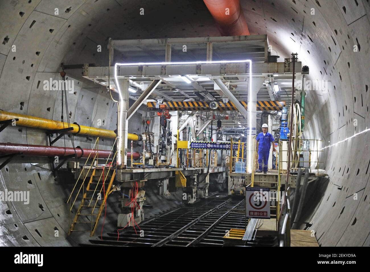 With the help of professional machines, workers are busy at building ...