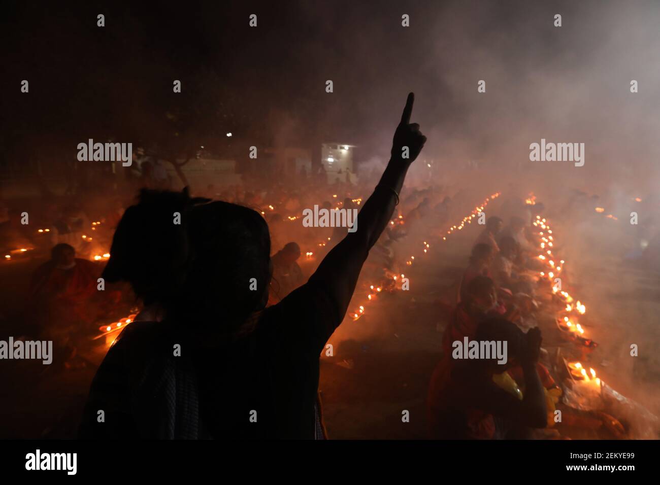 A devotee worshiping with her hand raised during the festival. Every ...