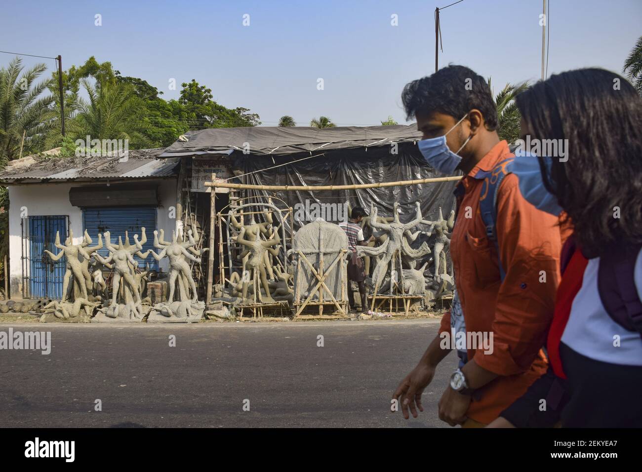Unfinished clay idols are placed under the sun to dry. The popular ...