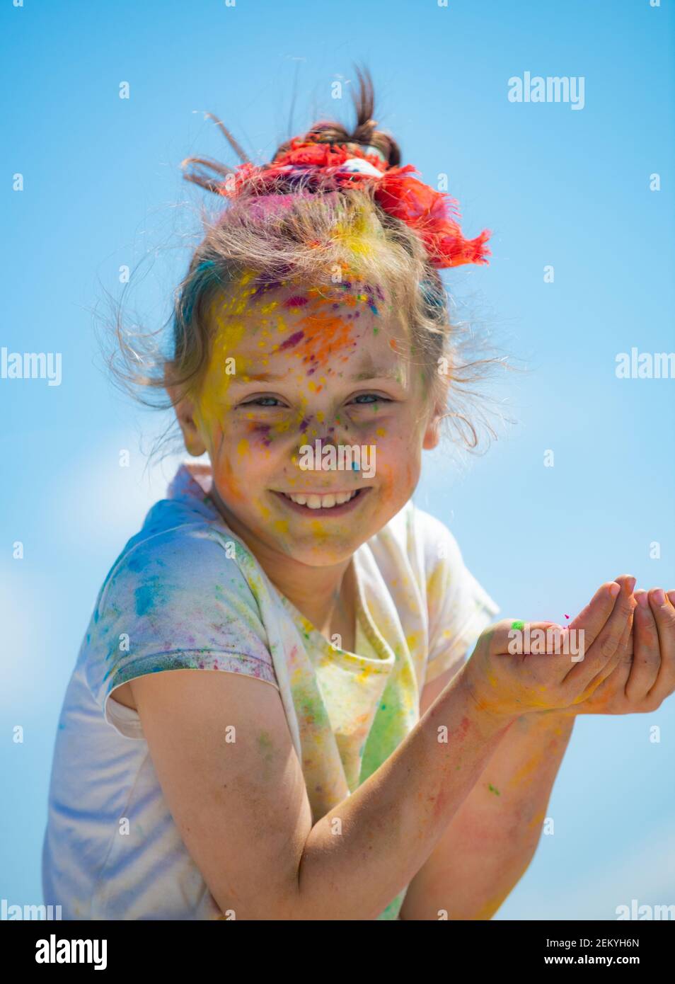 Kid holi festival. Painted face of funny child. Little boy plays with ...