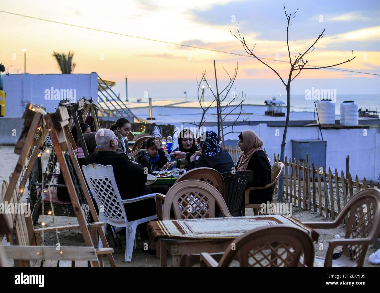 People sitting at a coffee shop next to a beach in Gaza City. (Photo by ...