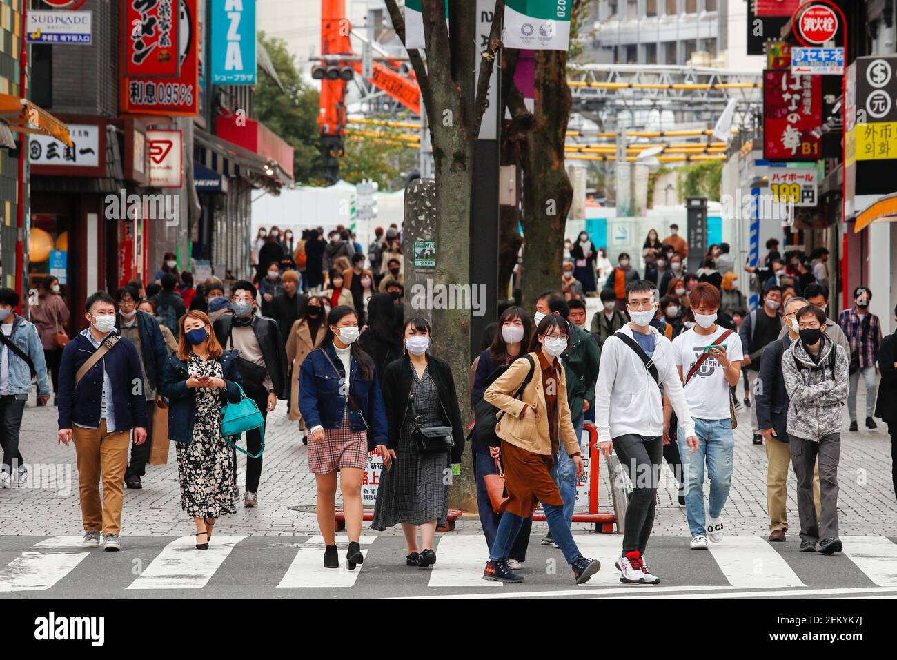 People wearing face masks at shopping district of Ginza in Tokyo, Japan ...