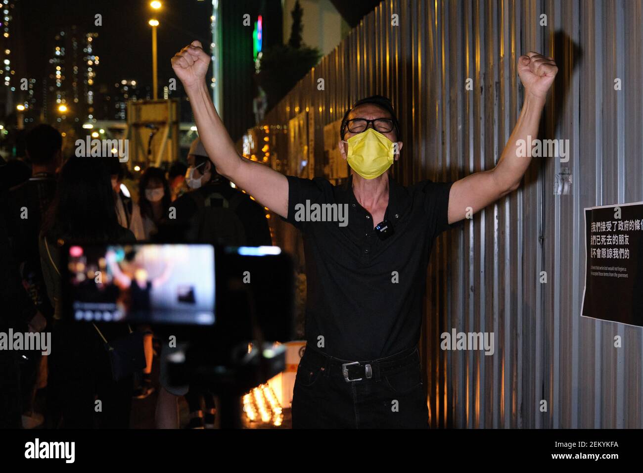 A man wearing a face mask prays as he pays tribute to Alex Chow Tsz-lok ...