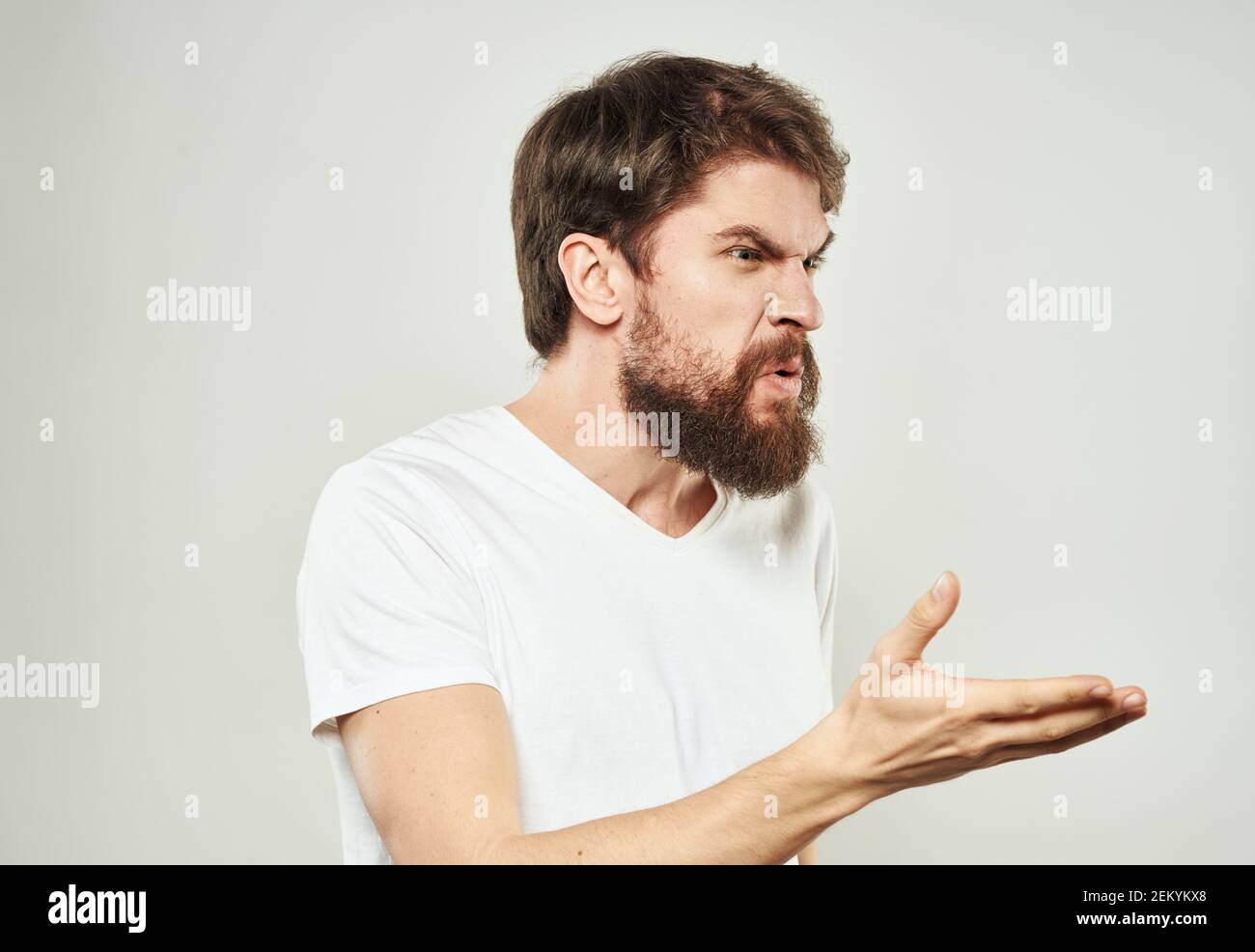 Aggressive man gestures with his hands thick beard irritability stress ...