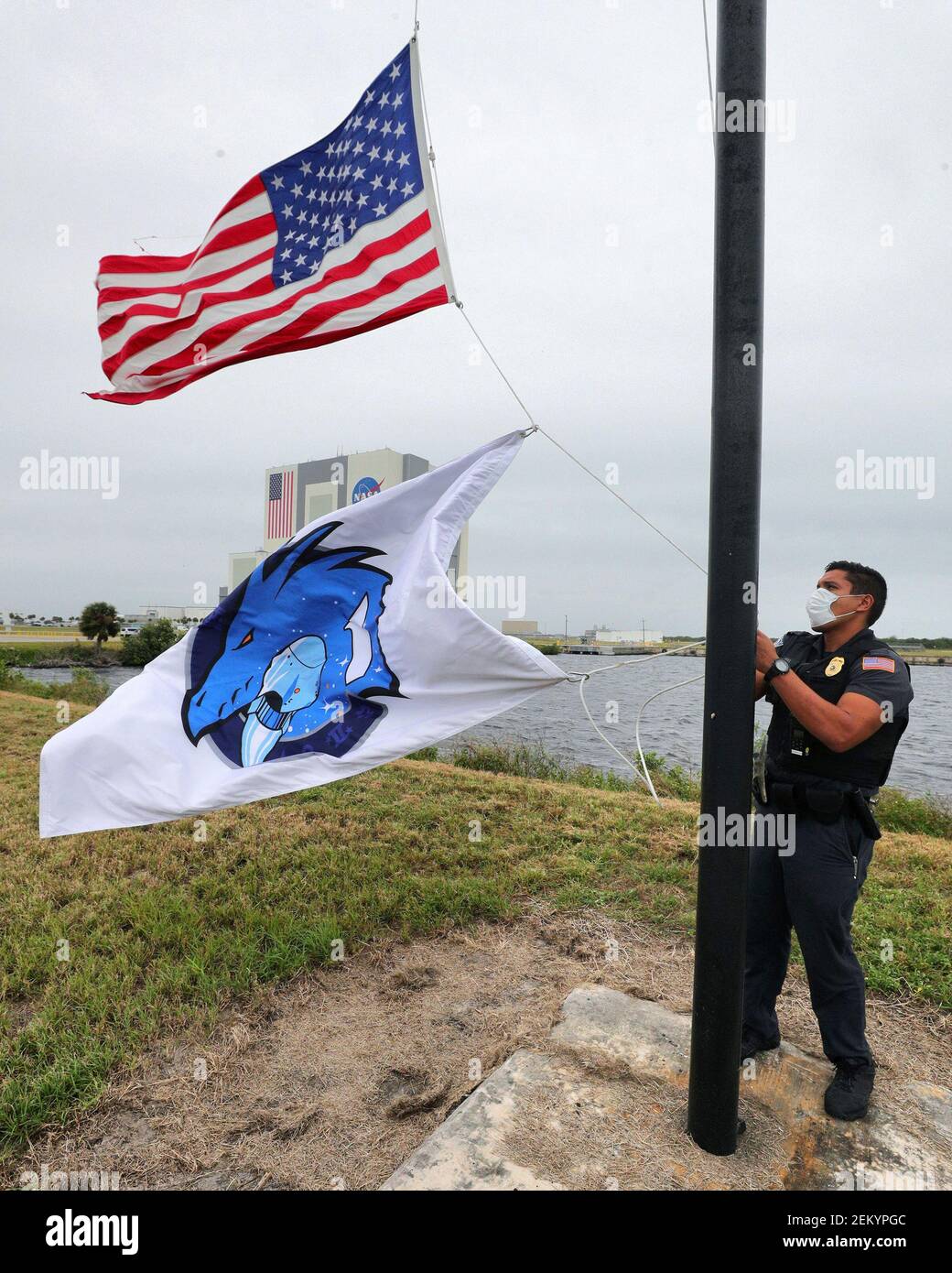 The mission flag for SpaceX Crew-1 is raised at Kennedy Space Center ...