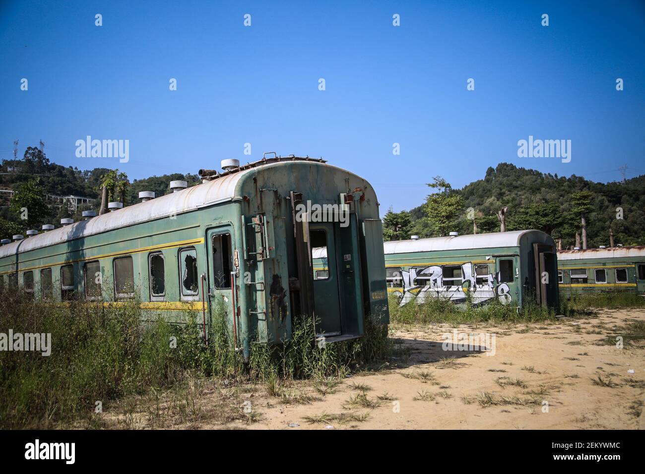 There are piles of abandoned green-skinned trains on the train ...