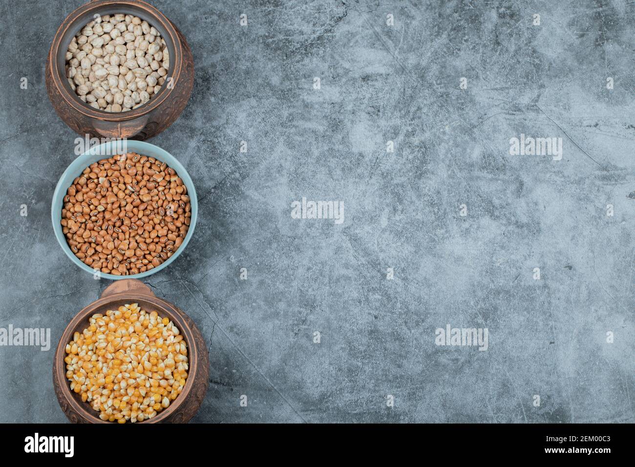 Different kinds of raw beans on a gray background Stock Photo - Alamy
