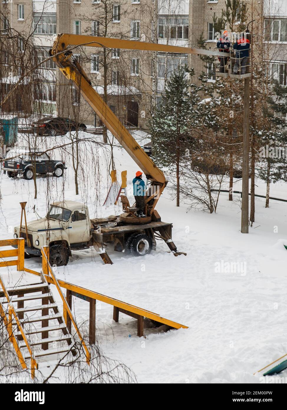 Car crane with workers repairing city lighting Stock Photo - Alamy