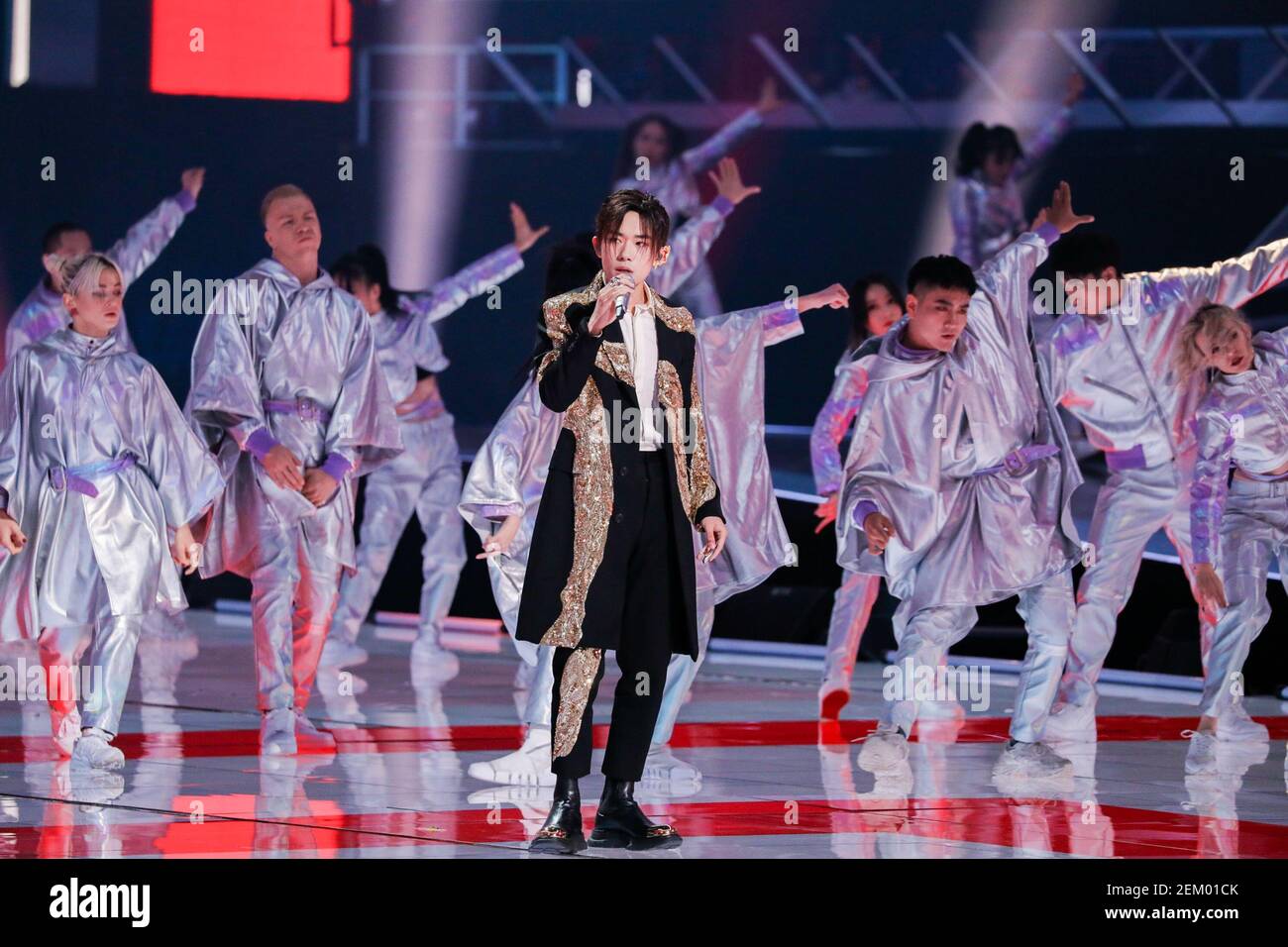 Chinese singer, dancer and actor Jackson Yee, middle, sings a song ...