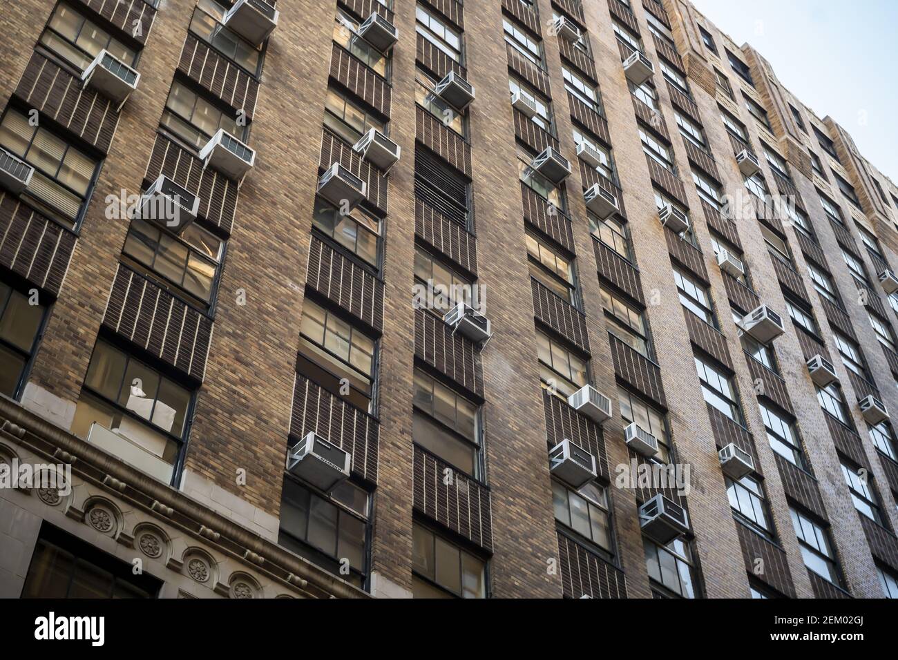 Air conditioners sprout from windows in a building in New York on ...