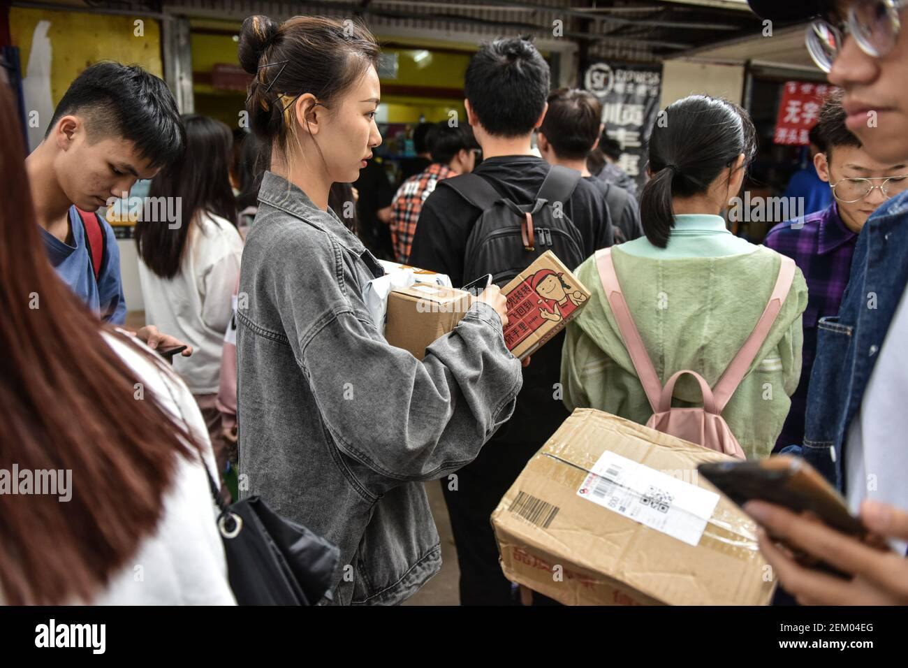 College students carrying packages at the express service during China ...