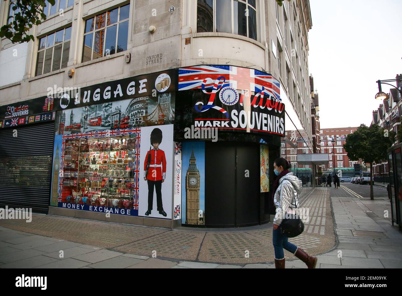A woman wearing a face mask as a precaution walking along Oxford Street ...