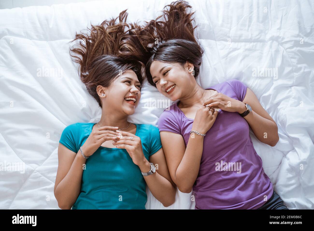 two young adult asian twin sister together. beautiful woman together in ...