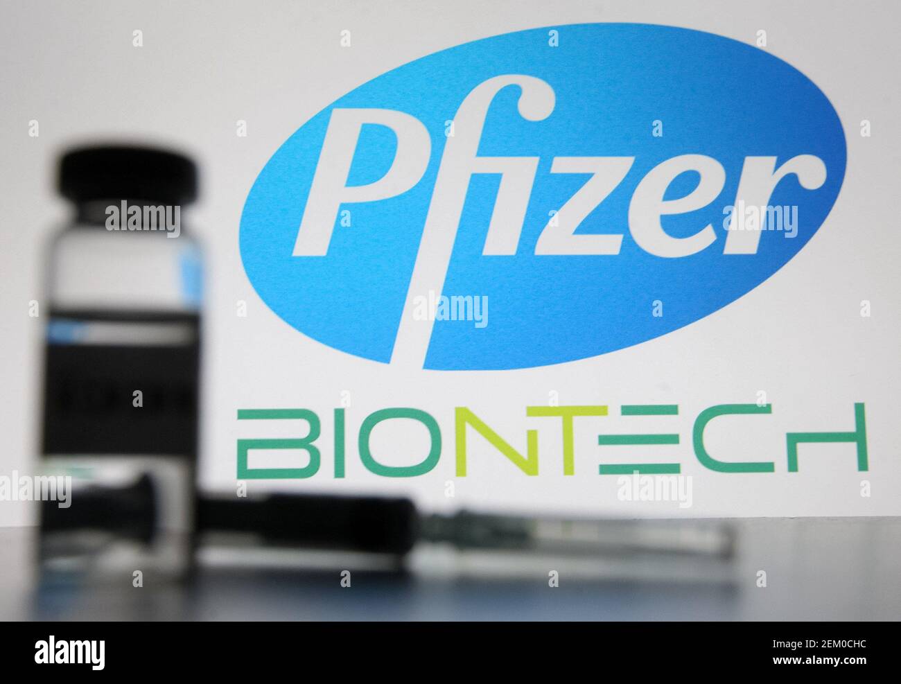 In this photo illustration a syringe and a small bottle seen in front ...