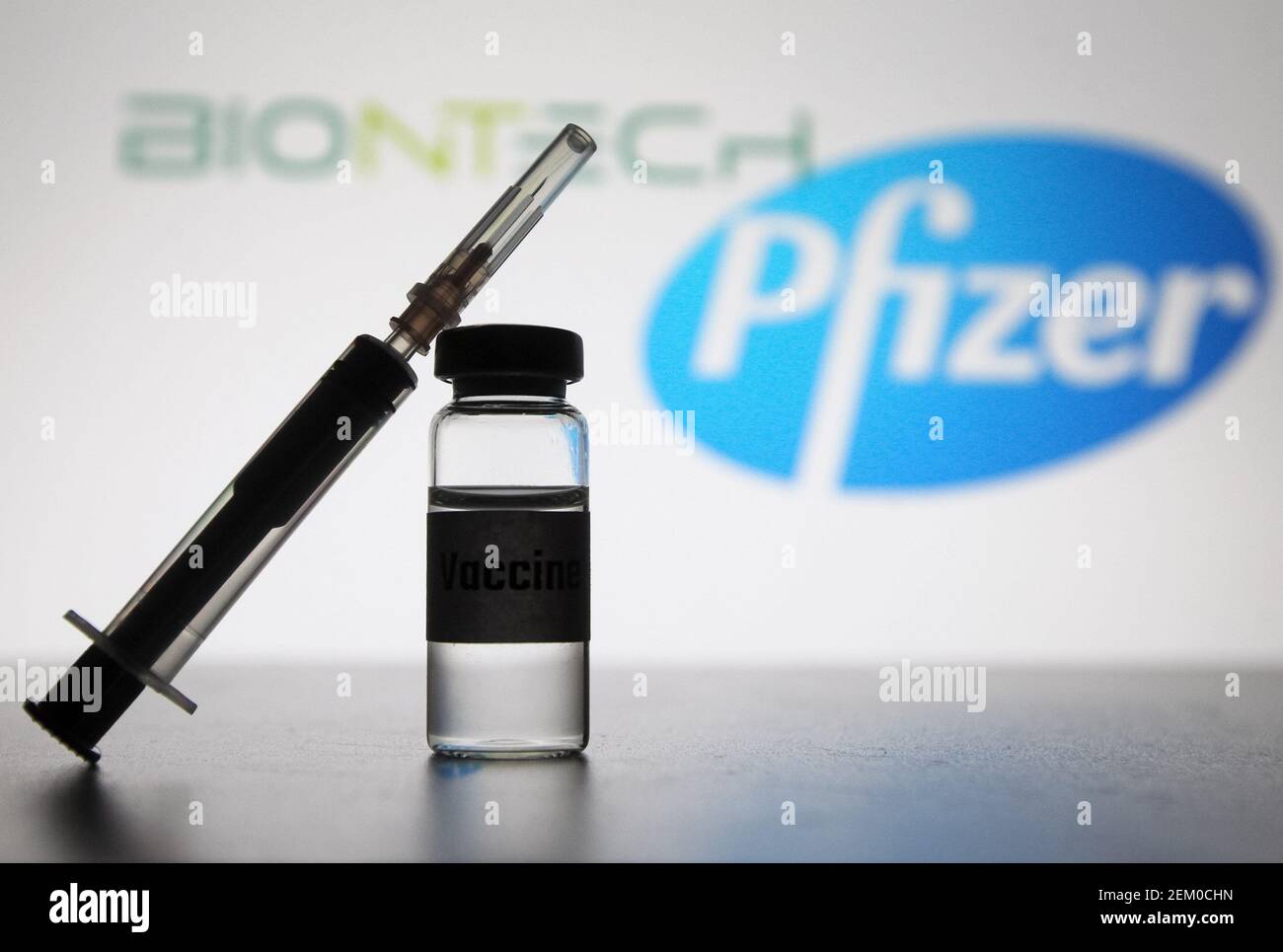 In this photo illustration a syringe and a small bottle seen in front ...