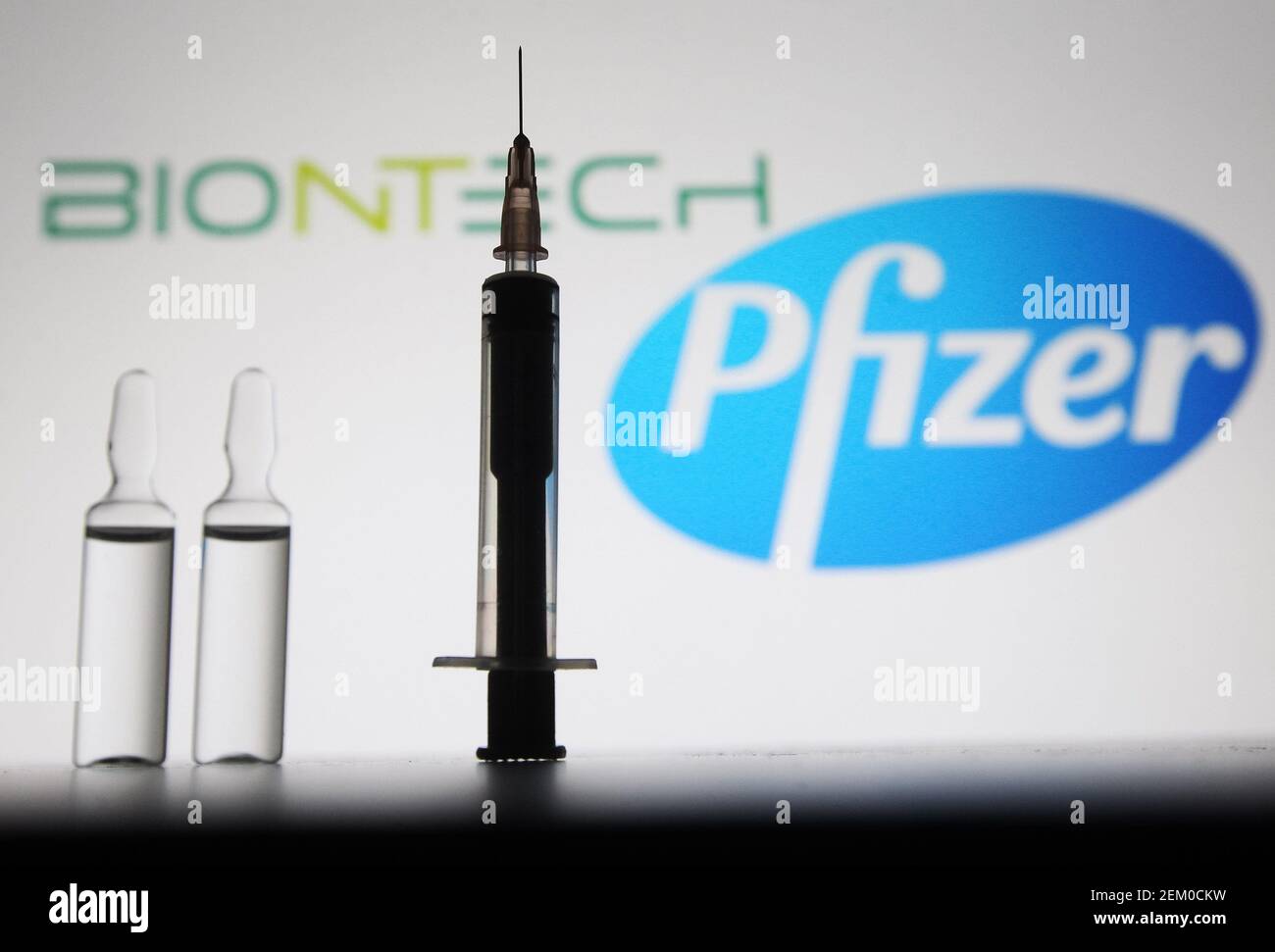 In this photo illustration a syringe and ampules seen in front of ...