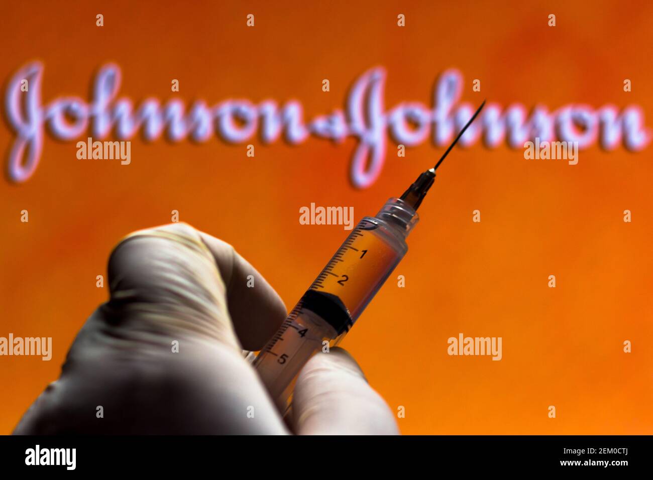 In this photo illustration a medical syringe is seen with Johnson and ...