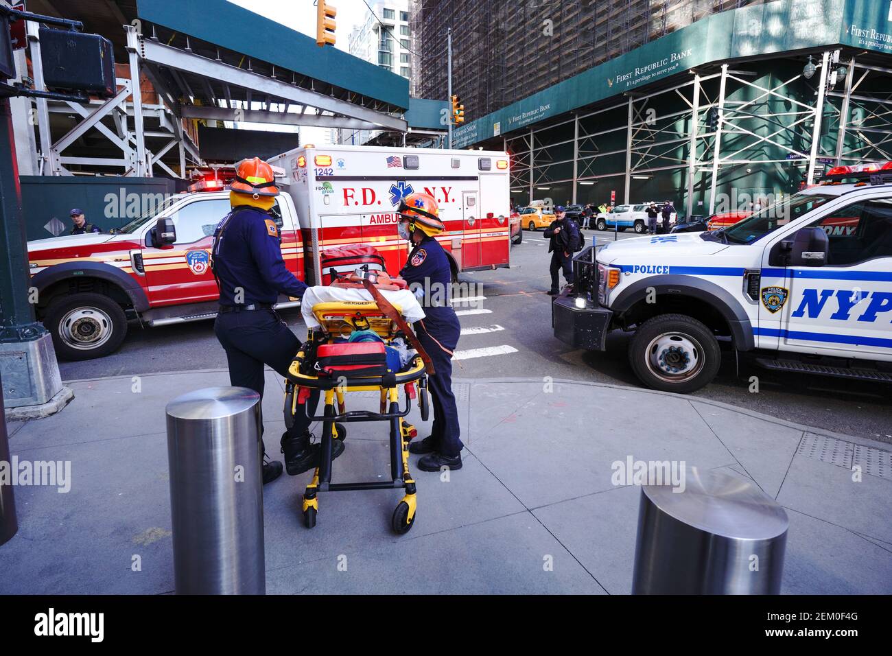 Medic workers wheel in a stretcher at a site where a scaffolding ...