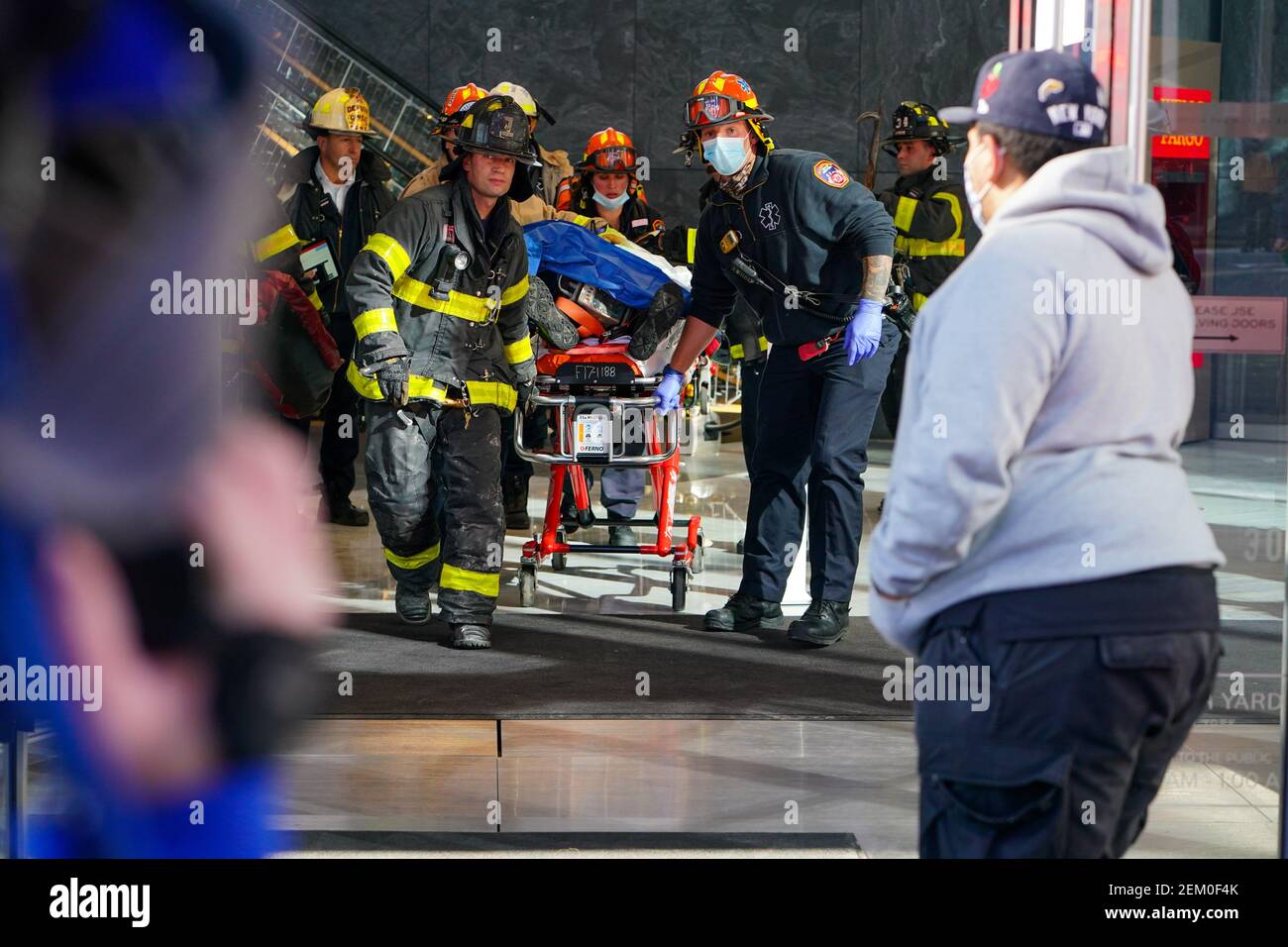 An injured construction worker seen on a stretcher. A scaffolding ...