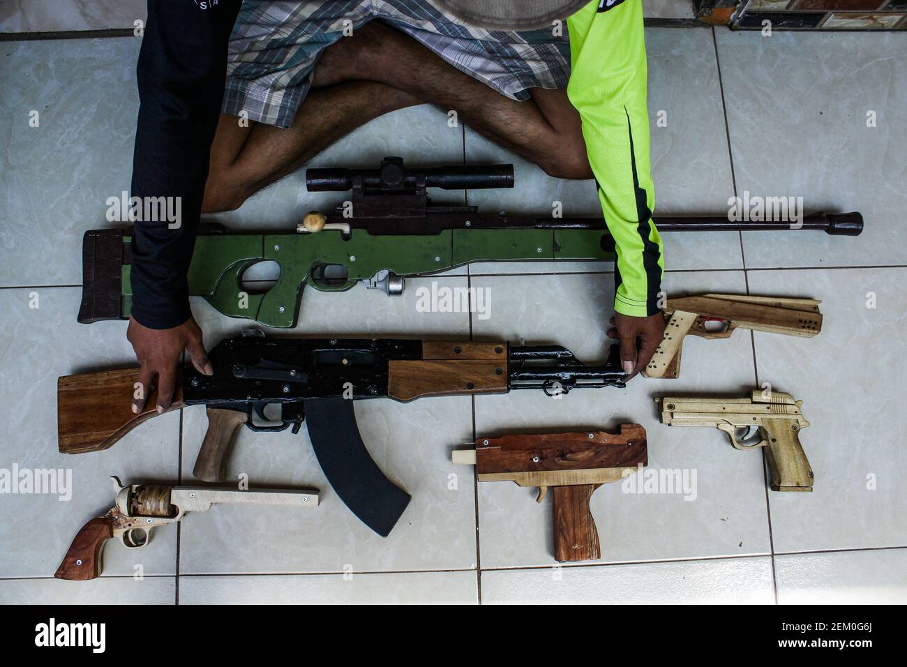 Yaya Saepuloh, displays replicas of wooden weapons inspired by an ...