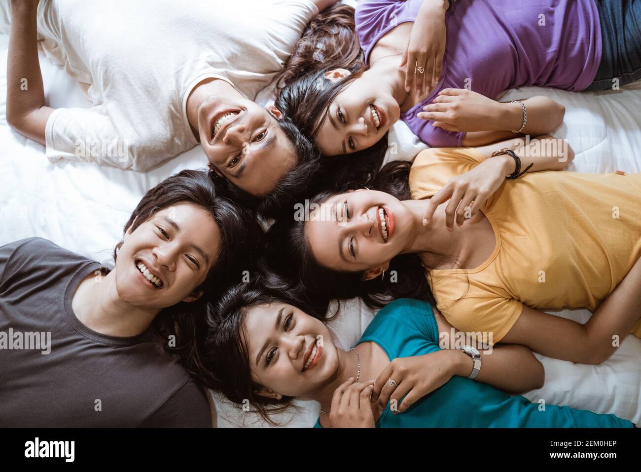 five asian young friend having fun together in the bedroom shot from ...