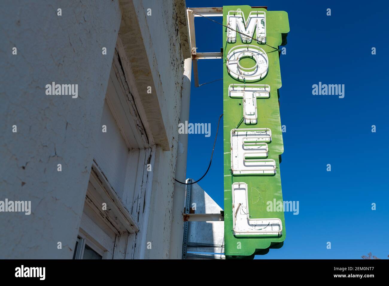 A green neon motel sign on the side of a building Stock Photo - Alamy