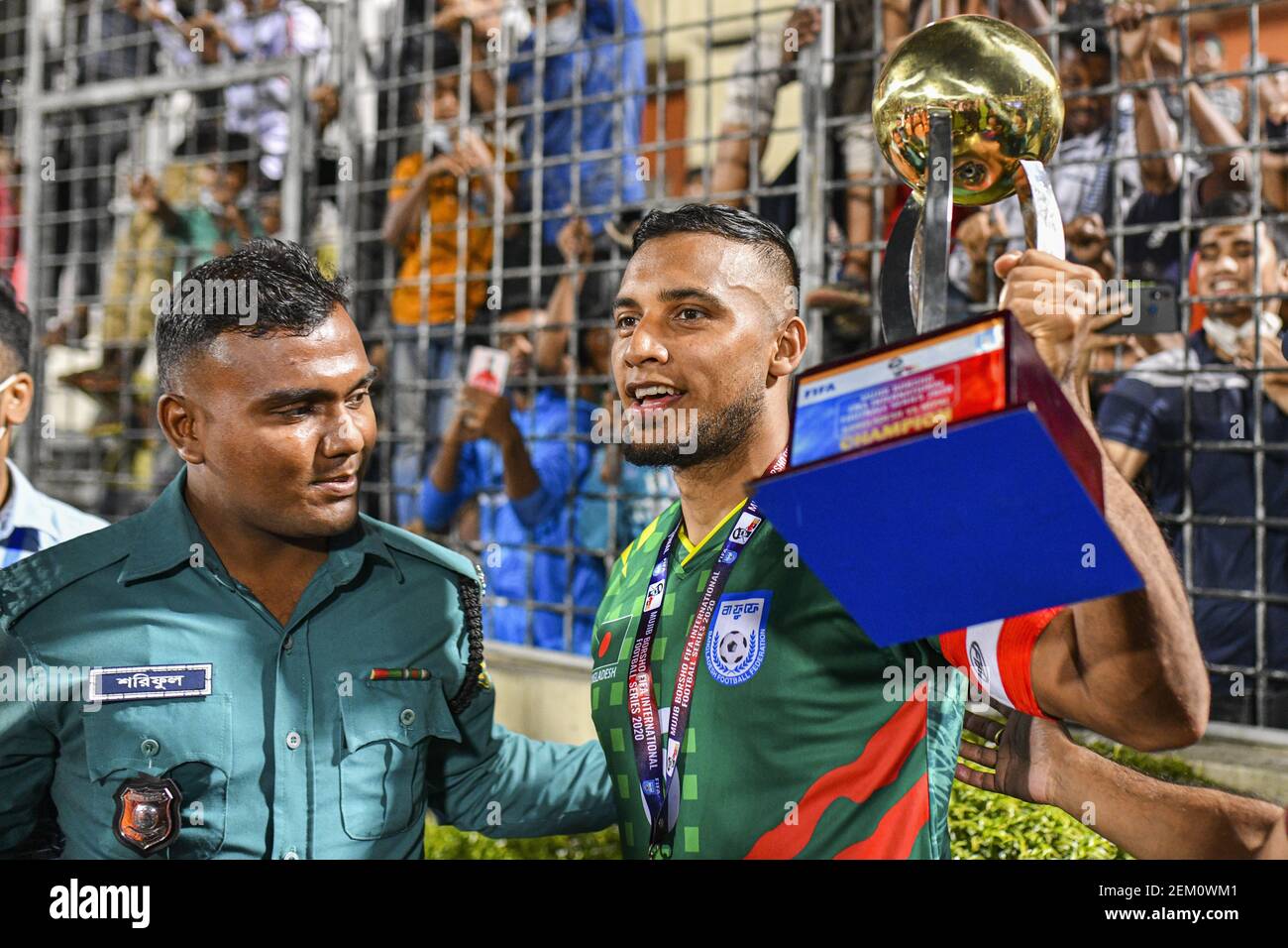 Bangladeshi captain Jamal Bhuiyan celebrates with the trophy during the ...