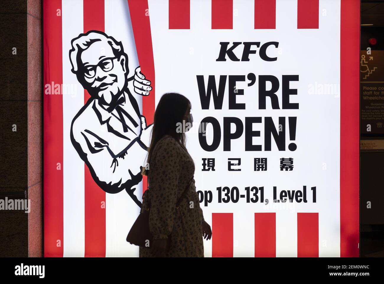 A commuter walking past an American fast food chicken restaurant chain ...