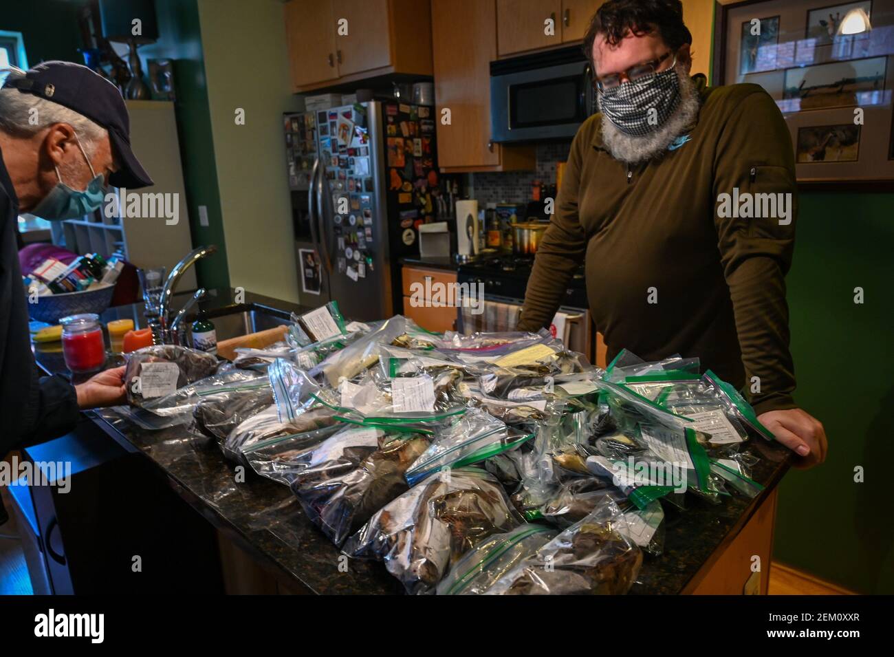 Baltimore Bird Club president Joe Corcoran (left) looks over Lights Out ...