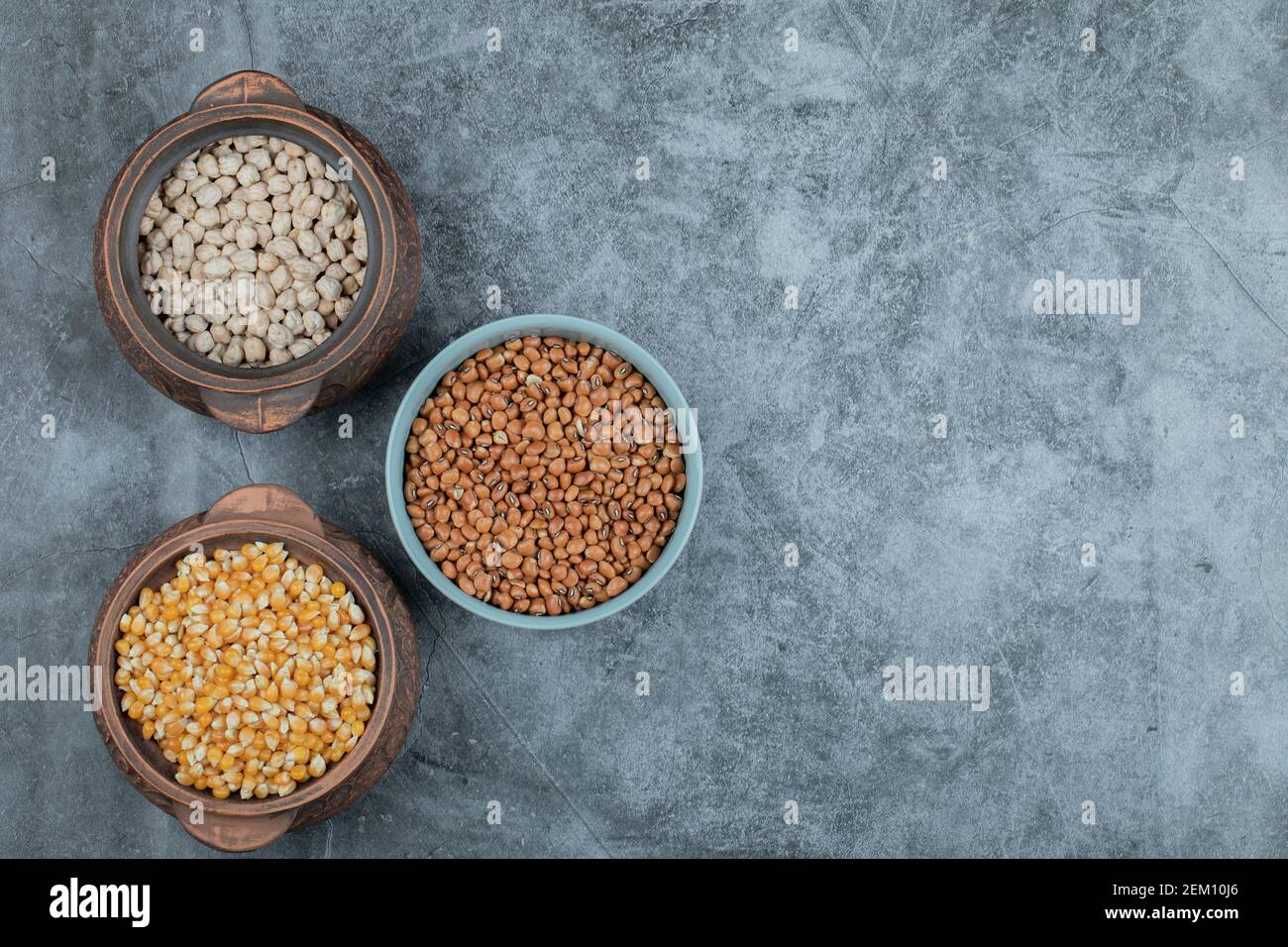 Different kinds of uncooked beans and corns in various pots Stock Photo ...