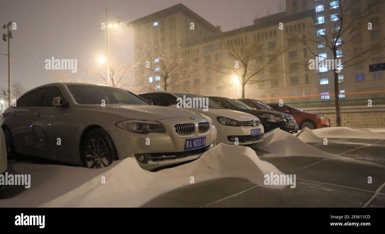 People walks and rides during the first snow fall of the season in ...