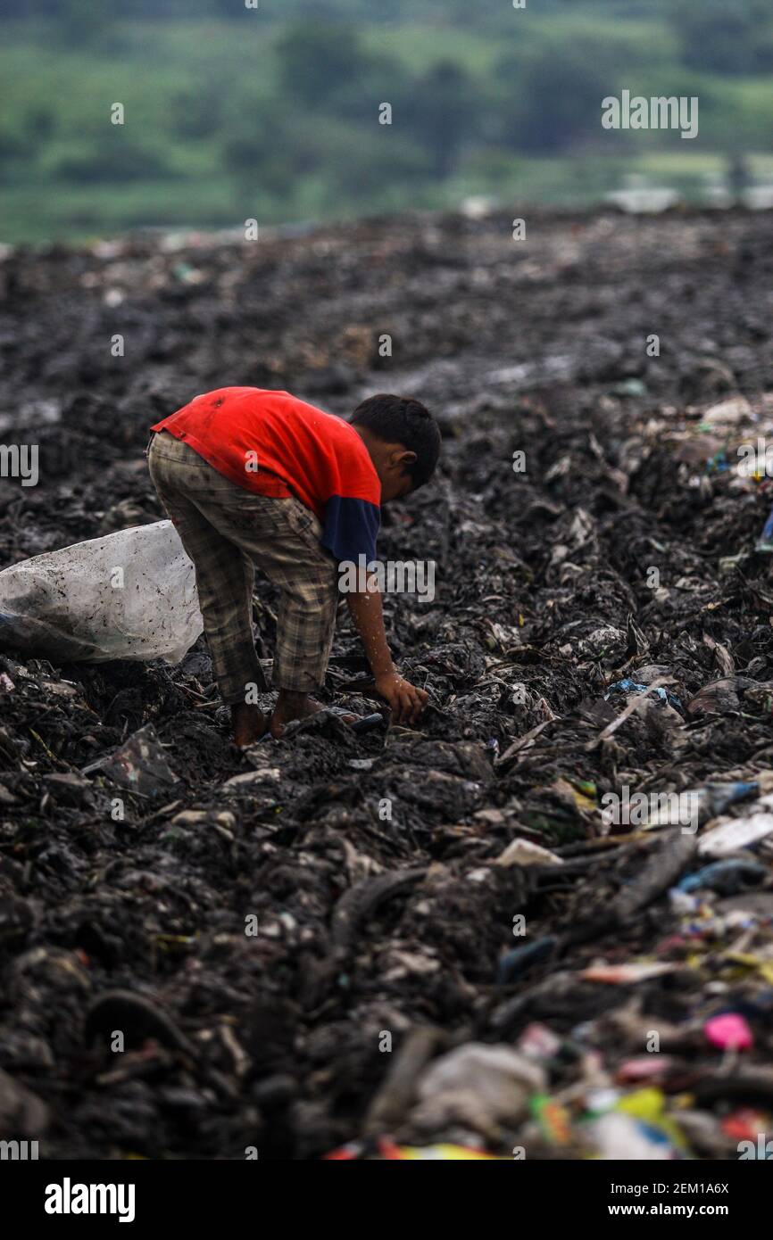 A child of a scavenger community, helps his parents who work as ...