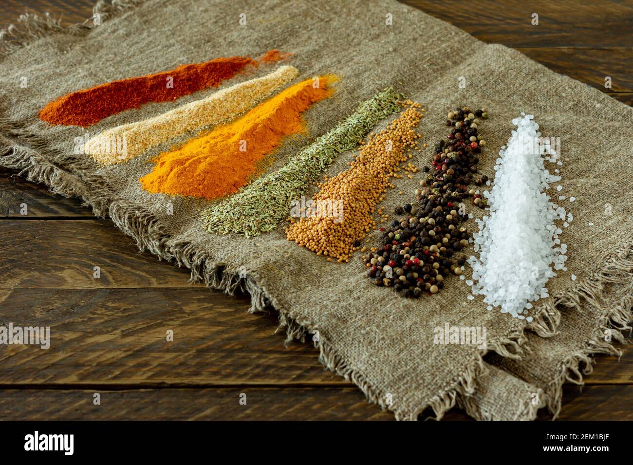 Various powder spices on wooden table. Background with space for text ...