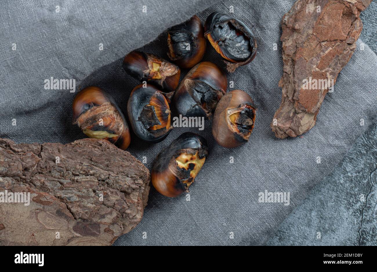 Delicious fried chestnuts on a tree bark Stock Photo - Alamy