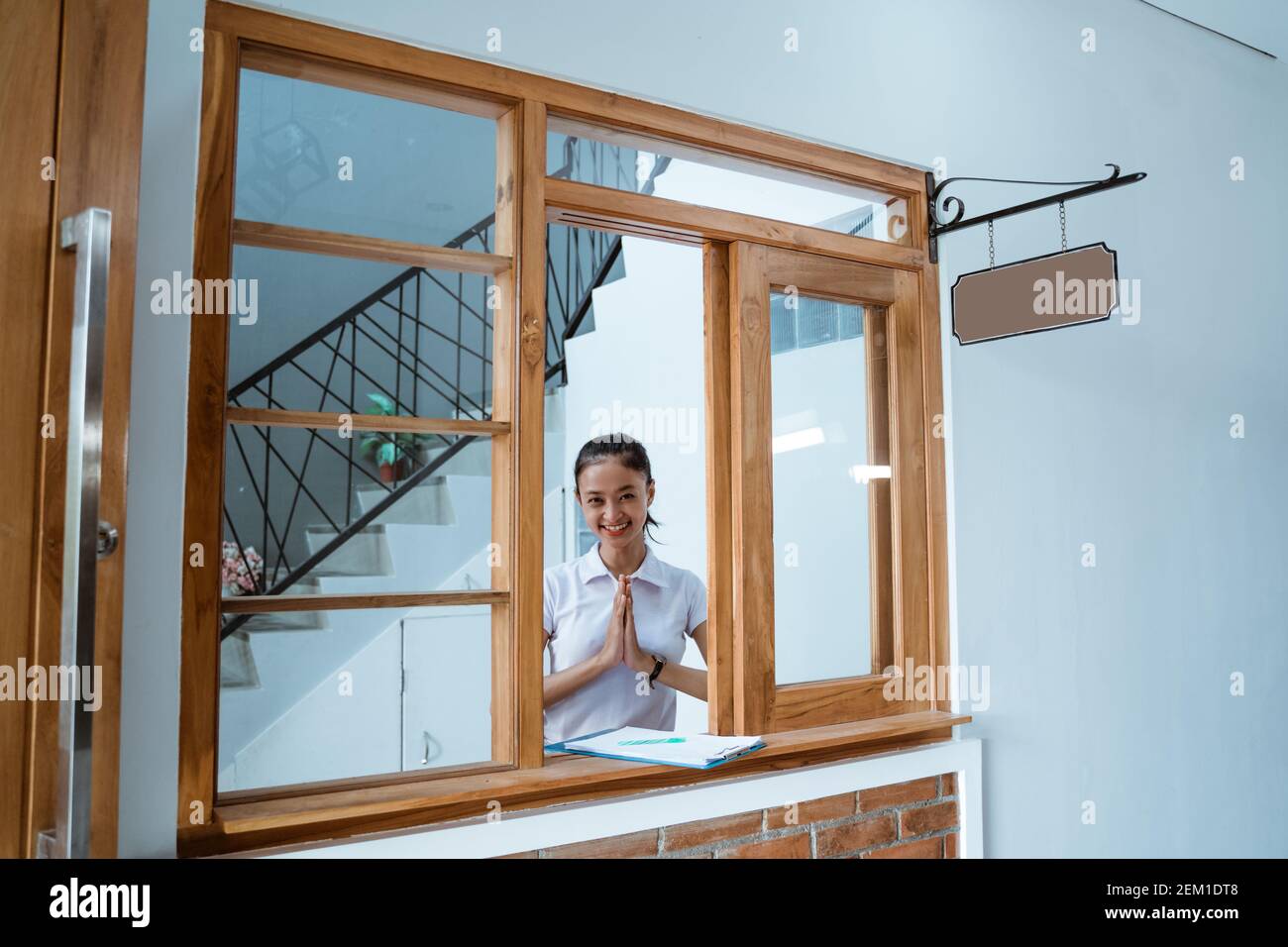 portrait of attractive homestay owner welcoming guest at her hotel ...