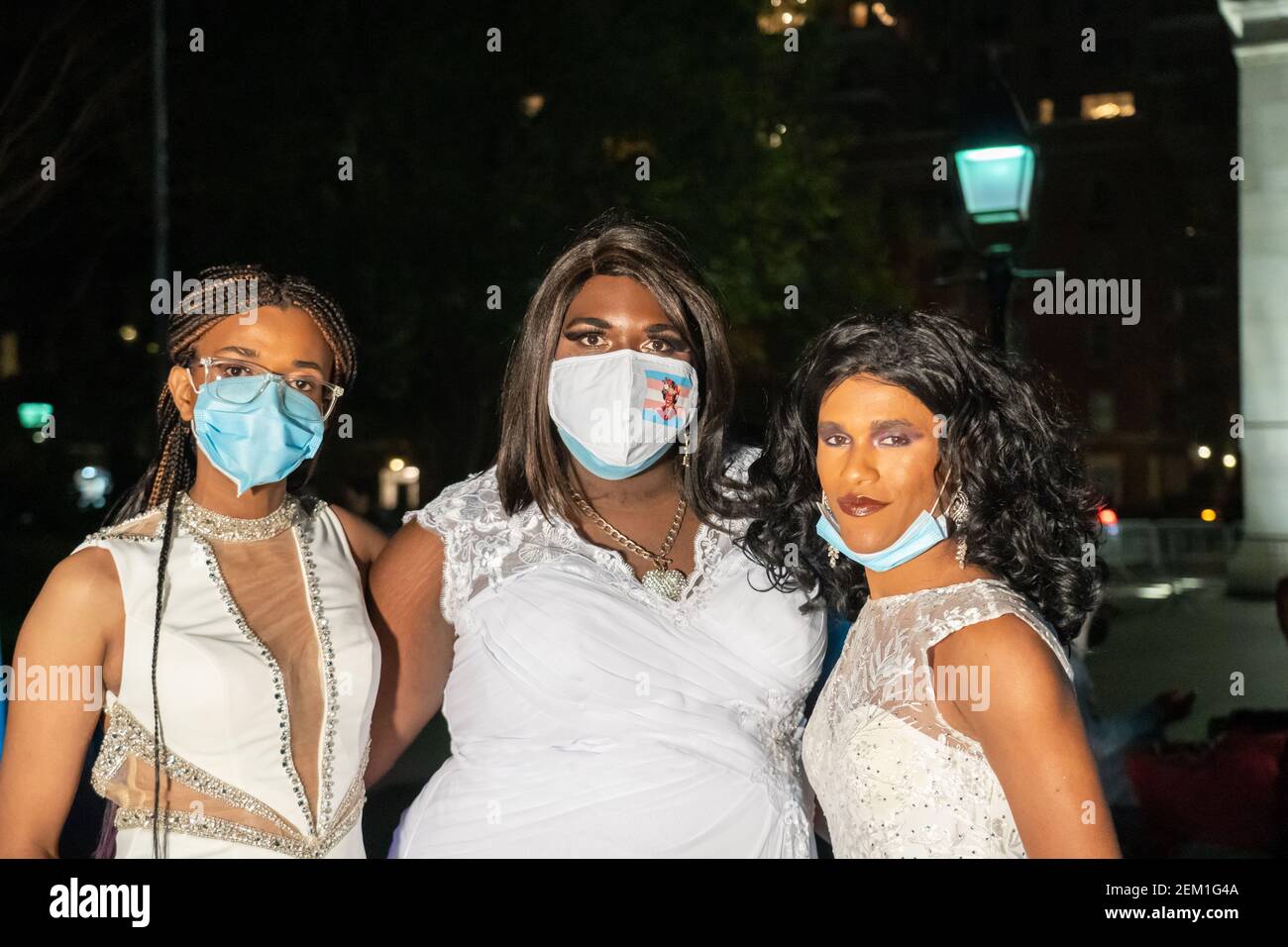 People wearing face mask attend the Transgender Day of Remembrance ...