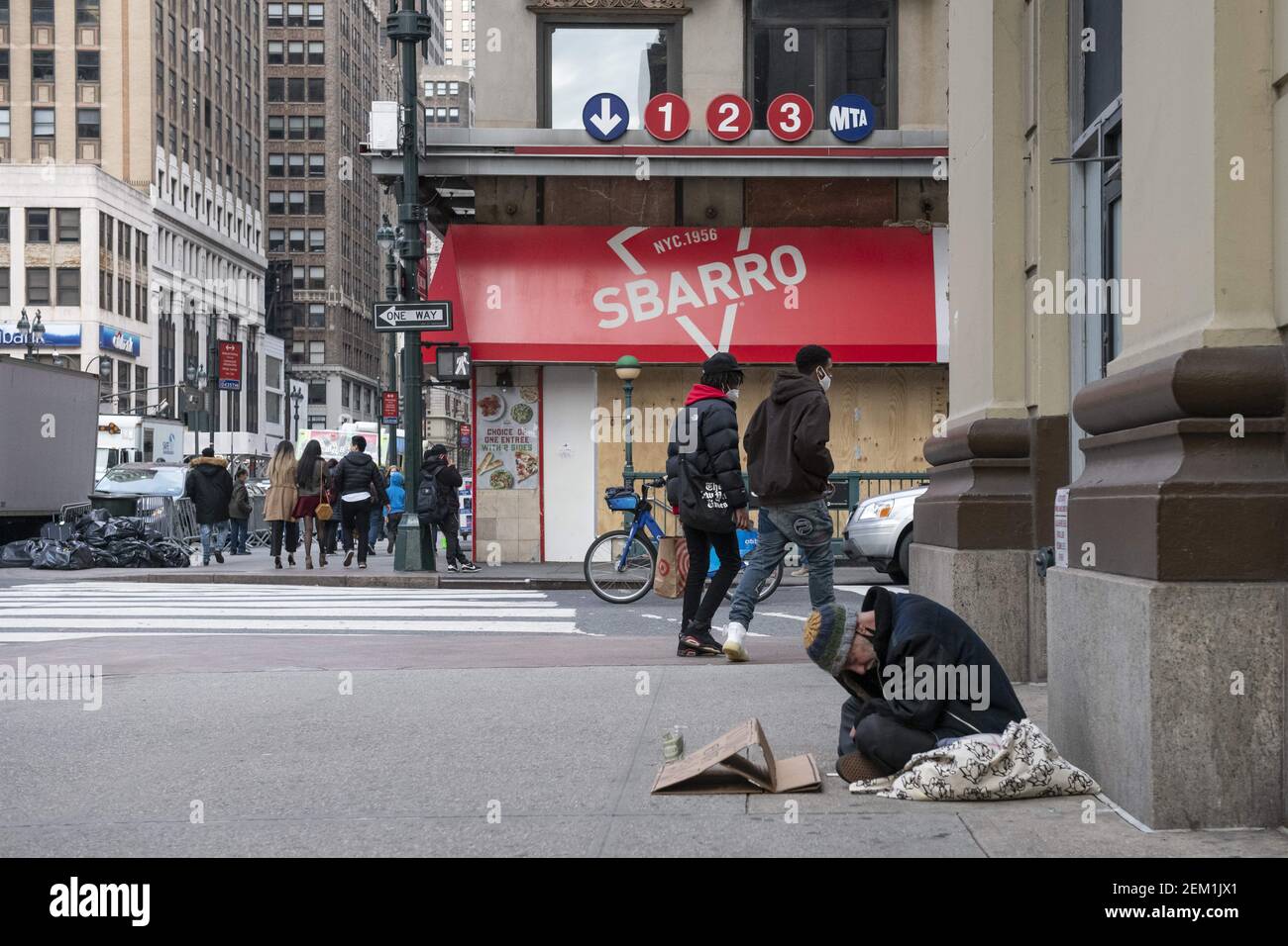 November 21, 2020: A homeless man sits on the street on 7th ave across ...
