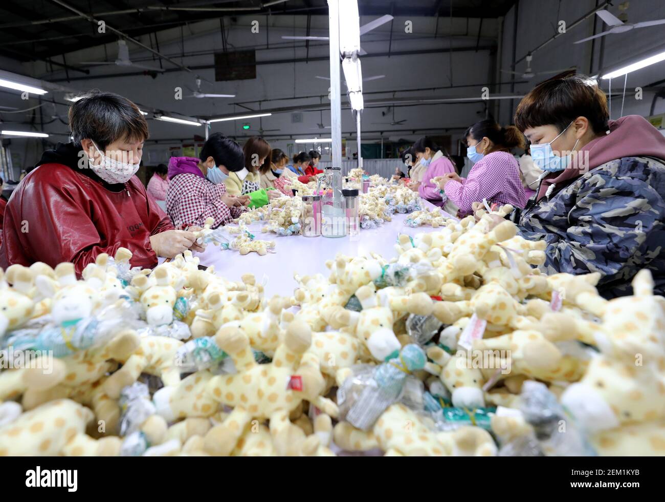 Factory workers make stuffed animals at a production workshop of a toy ...